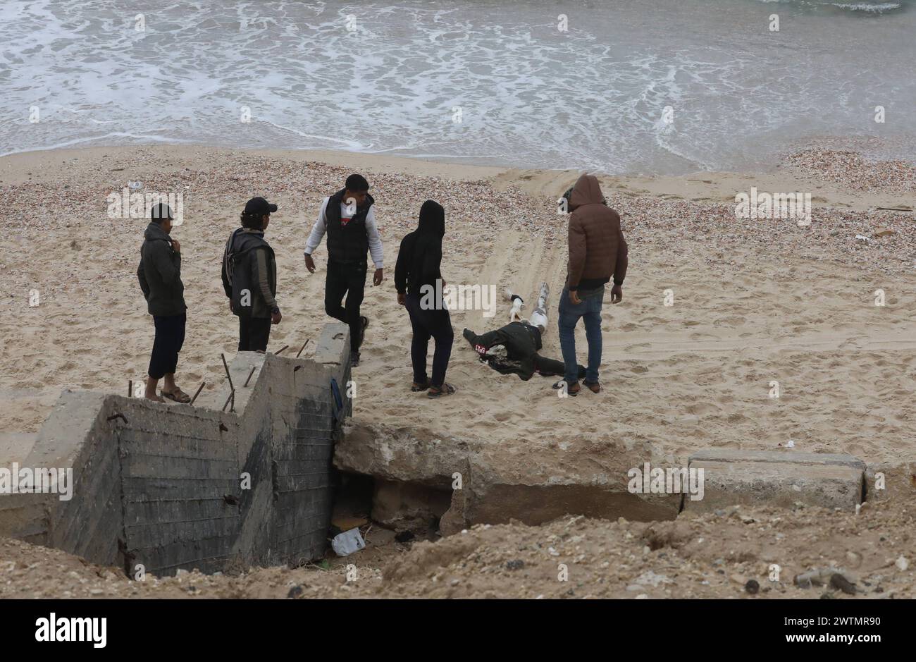 Palestinians prepare to bury a body on the beach near the Nuseirat ...