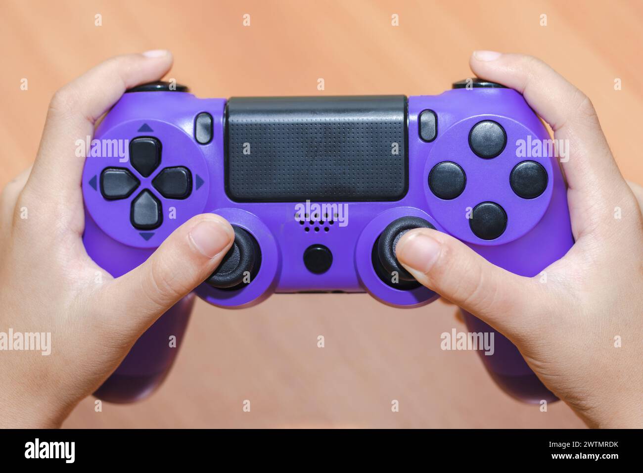 Close up of child hands playing the video game. shot of a child holding ...