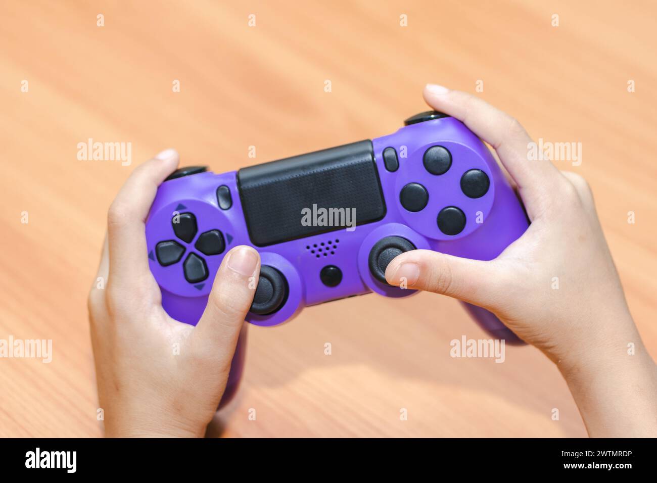 Close up of child hands playing the video game. shot of a child holding ...