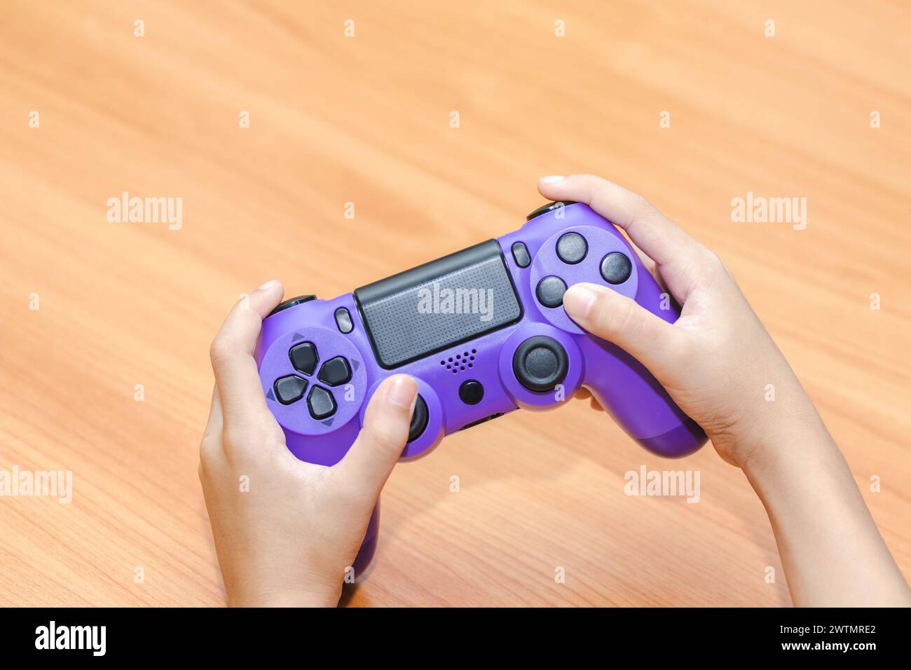 Close up of child hands playing the video game. shot of a child holding ...