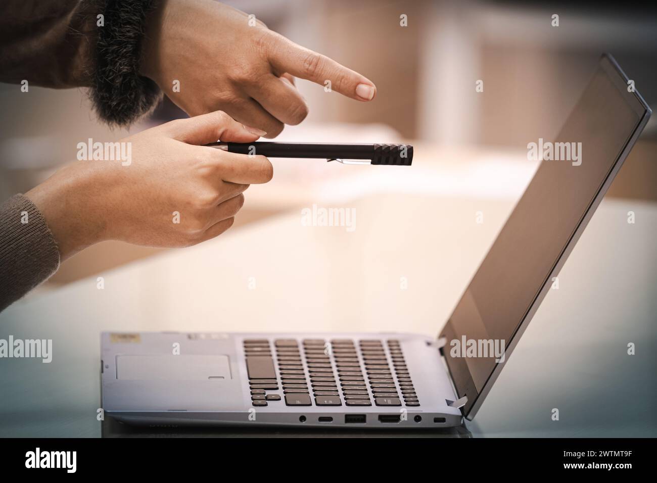 A woman pointing fingers at the laptop screen. Business meeting time ...
