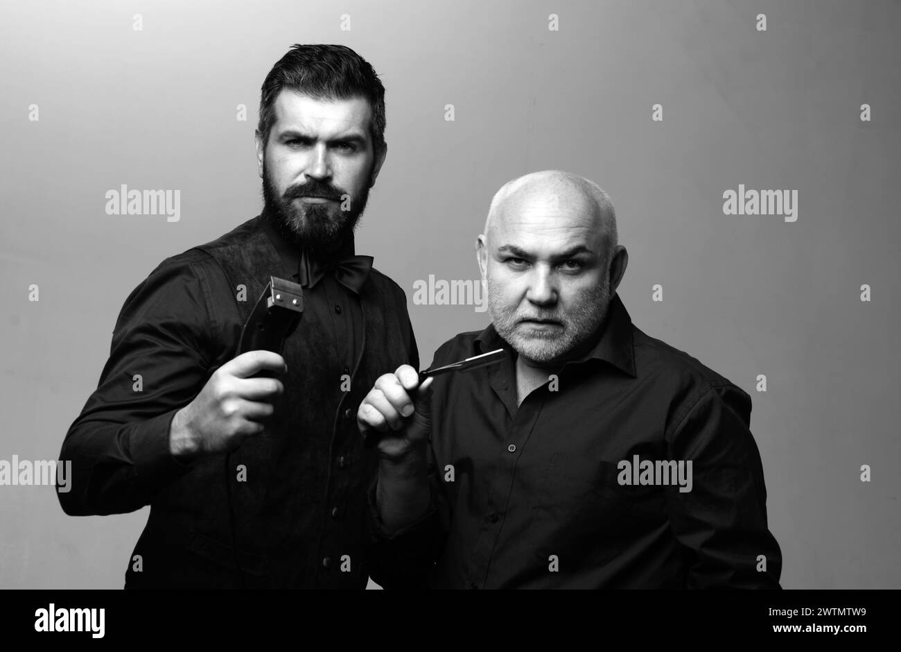 Barber shop. Two men posing with electric razor and blade. Bearded ...