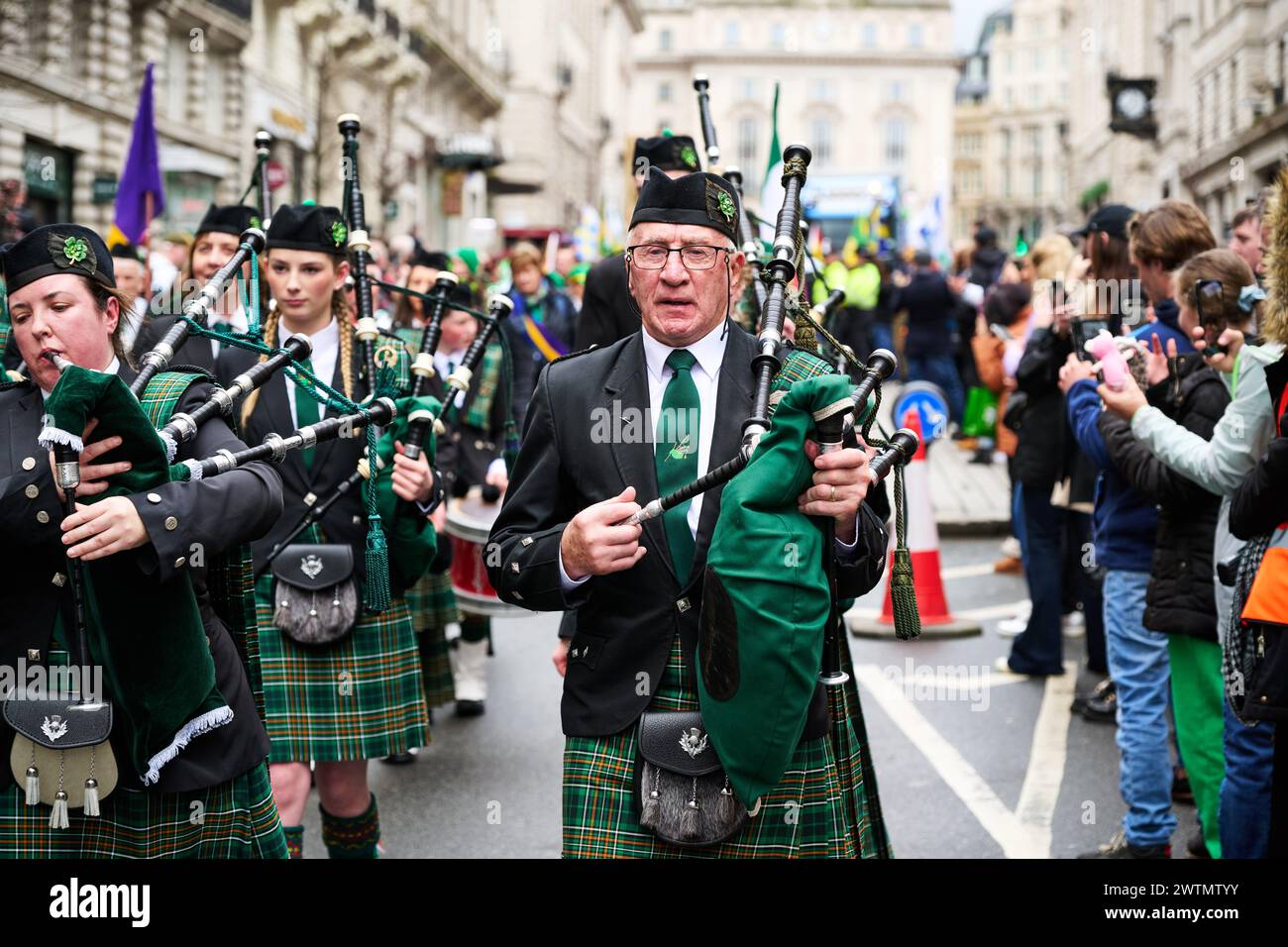 London, England, UK. 17th Mar, 2024. Bagpipe players join the ...