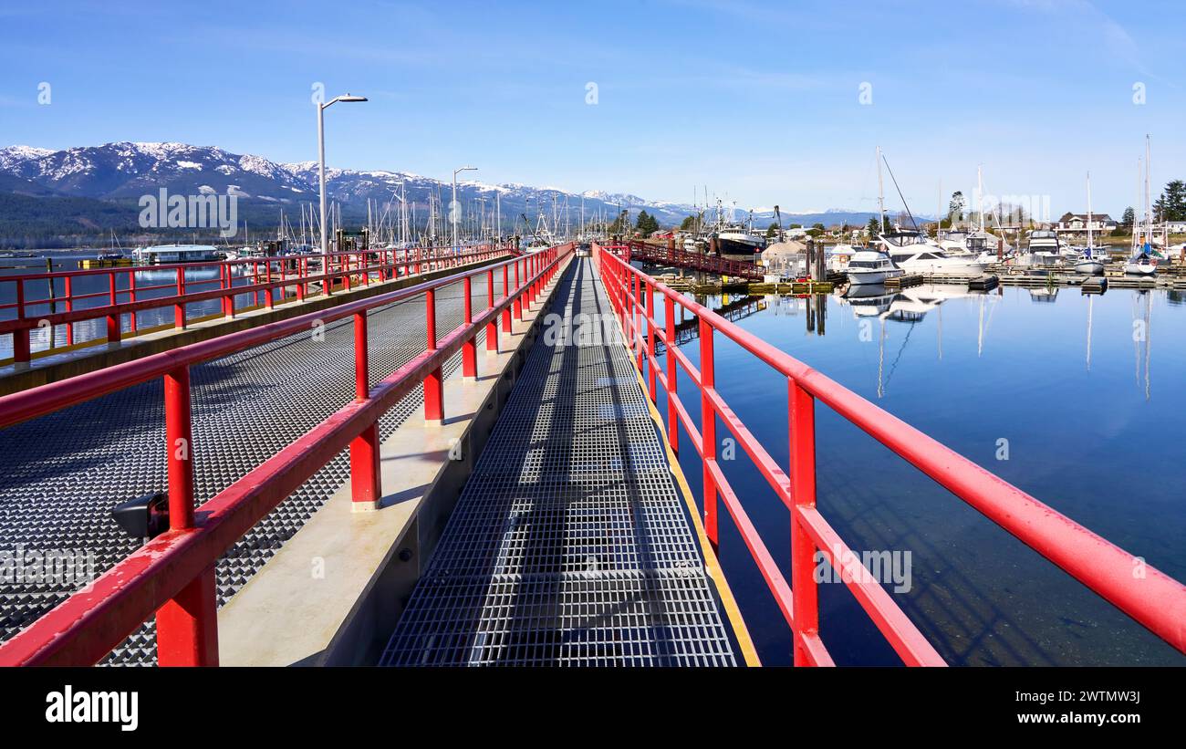 A long pier with bright red railings for vehicles and people walking ...