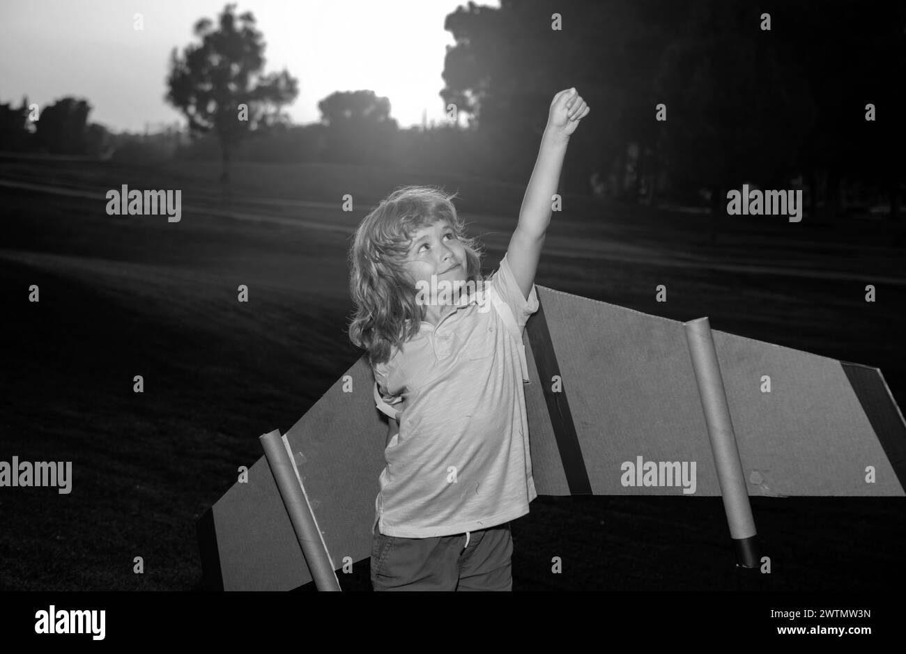 Kid superhero with jetpack. Child pilot play on summer day at sunset ...