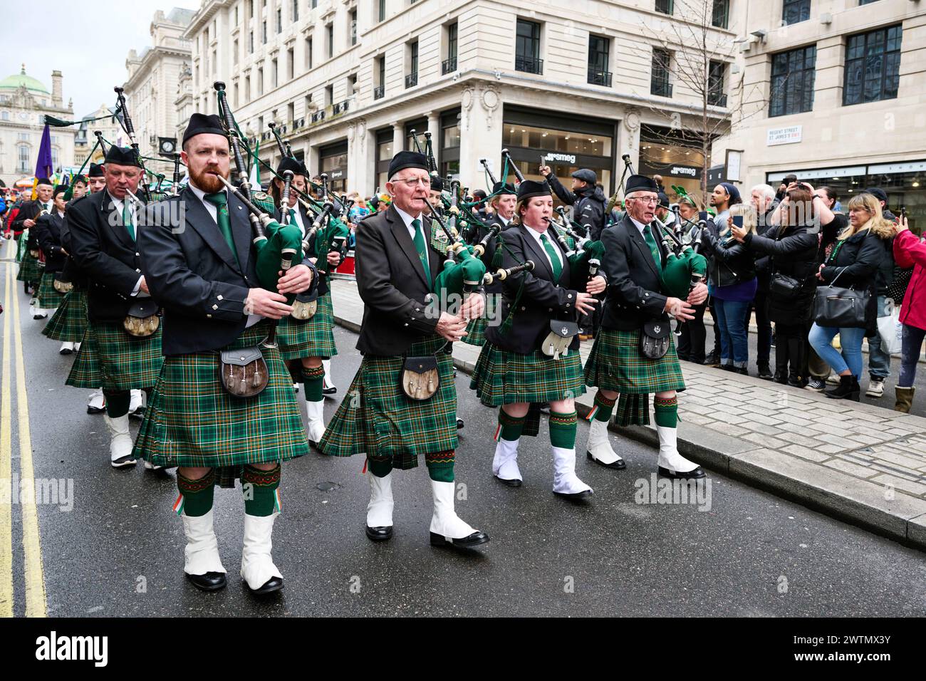 London, England, UK. 17th Mar, 2024. Bagpipe players join the ...