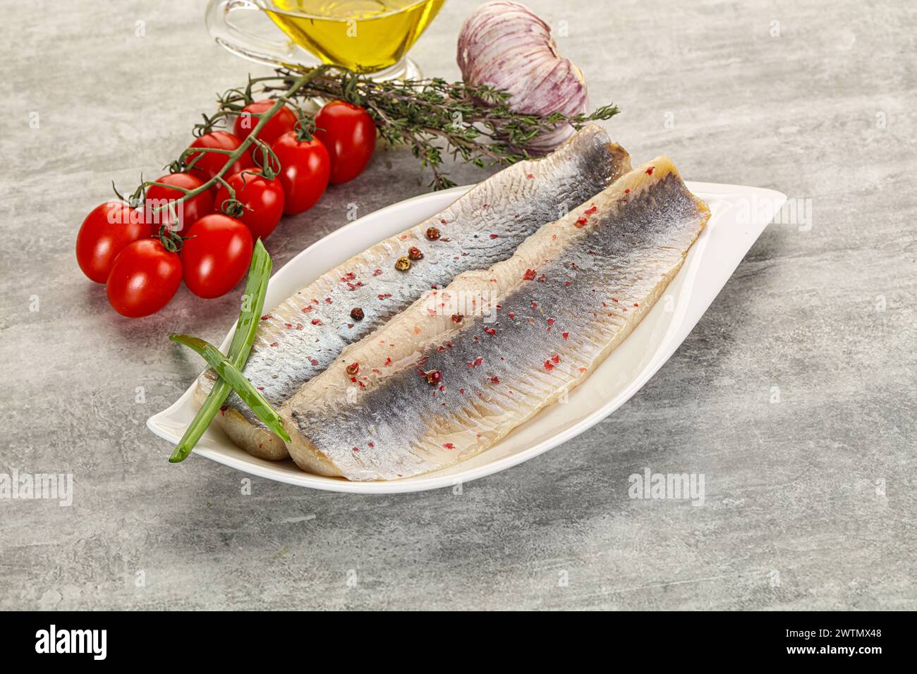 Marinated salted herring fillet with green onion Stock Photo - Alamy