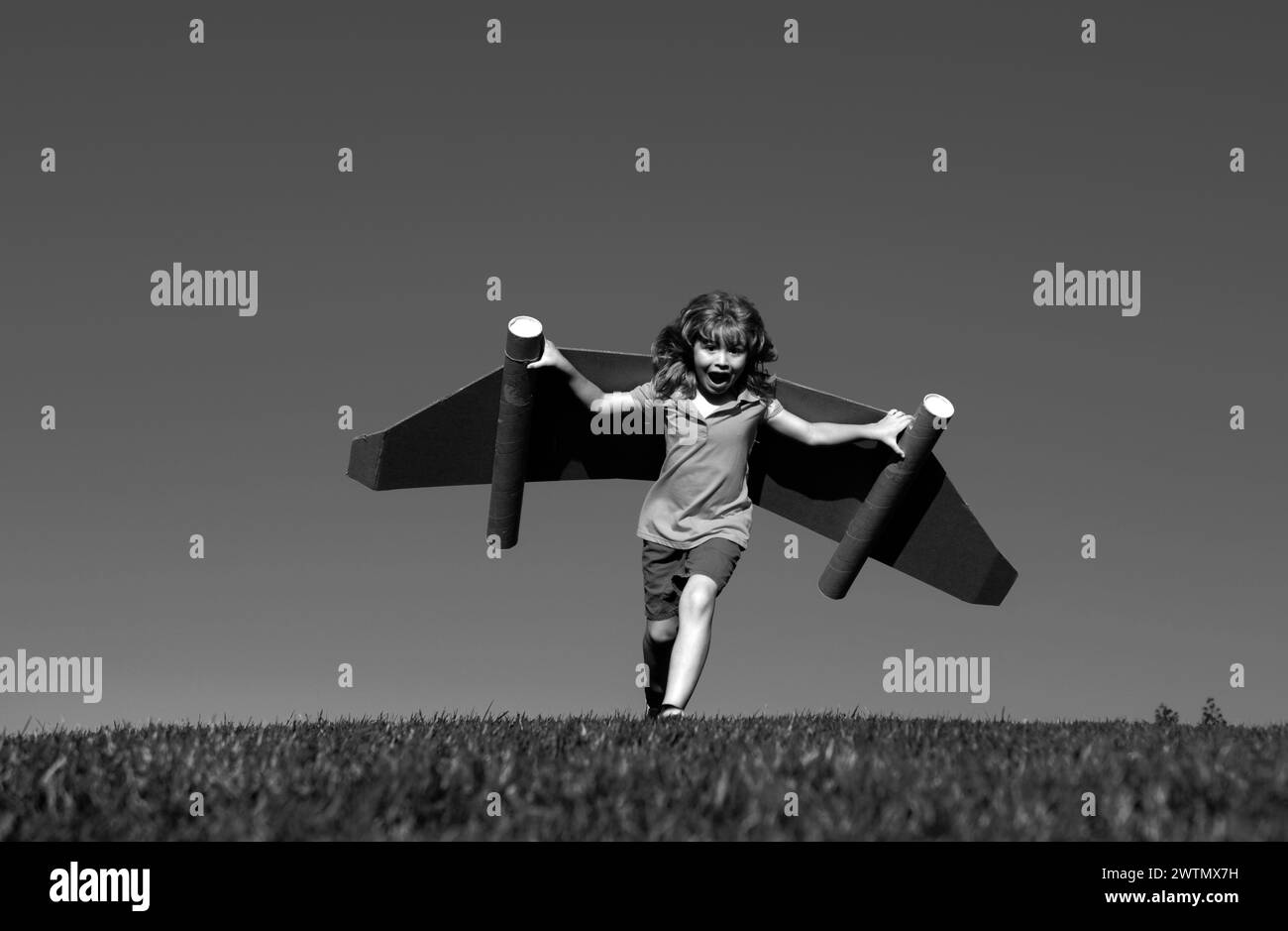 Happy child playing with toy jetpack. Kid pilot having fun outdoor ...