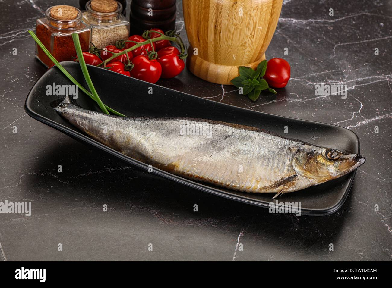 Whole raw salted herring fish in the plate Stock Photo - Alamy