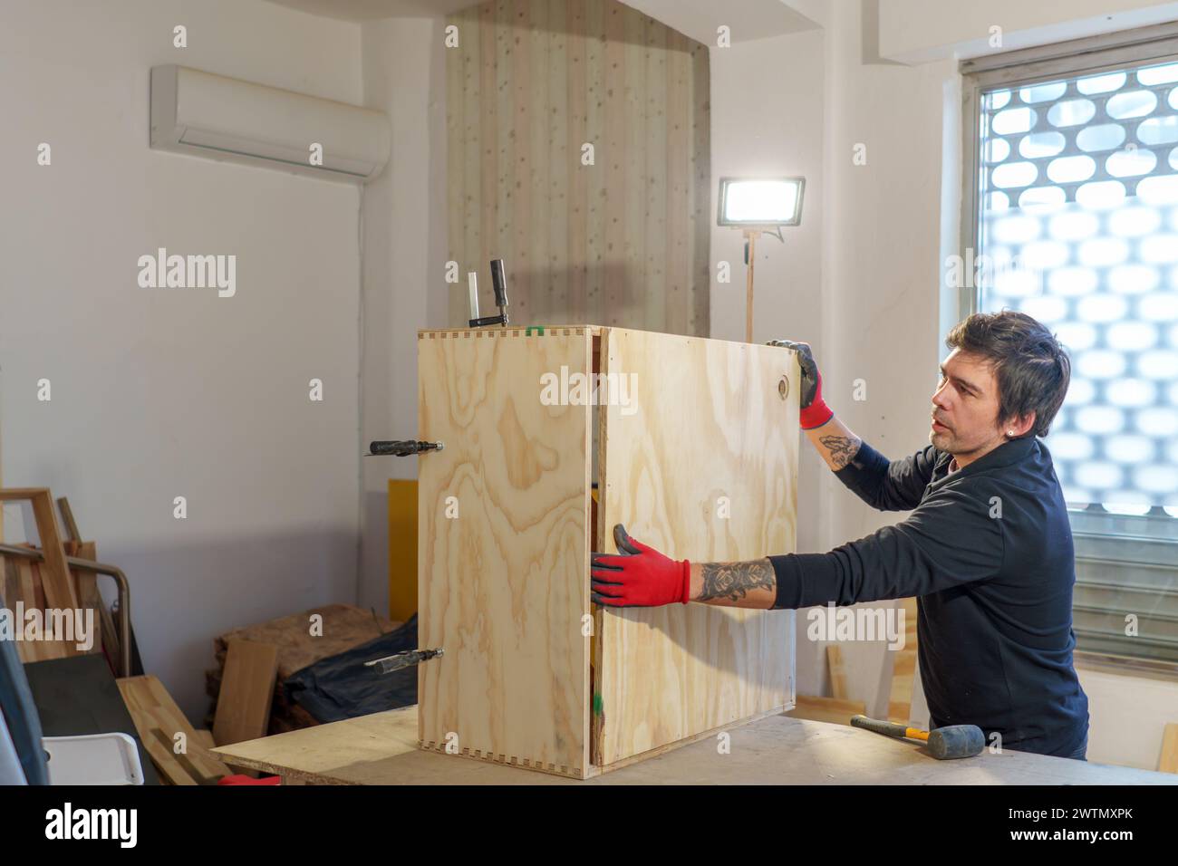 Middle aged Hispanic carpenter man working standing in his carpentry ...