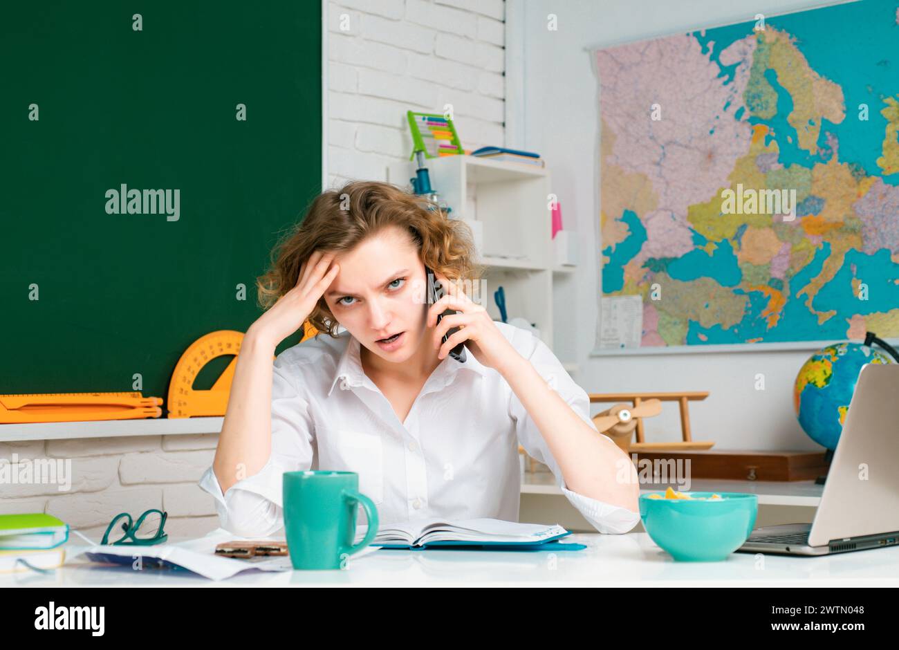 School angry teacher talking on smartphone. Education concept. Tutor in ...