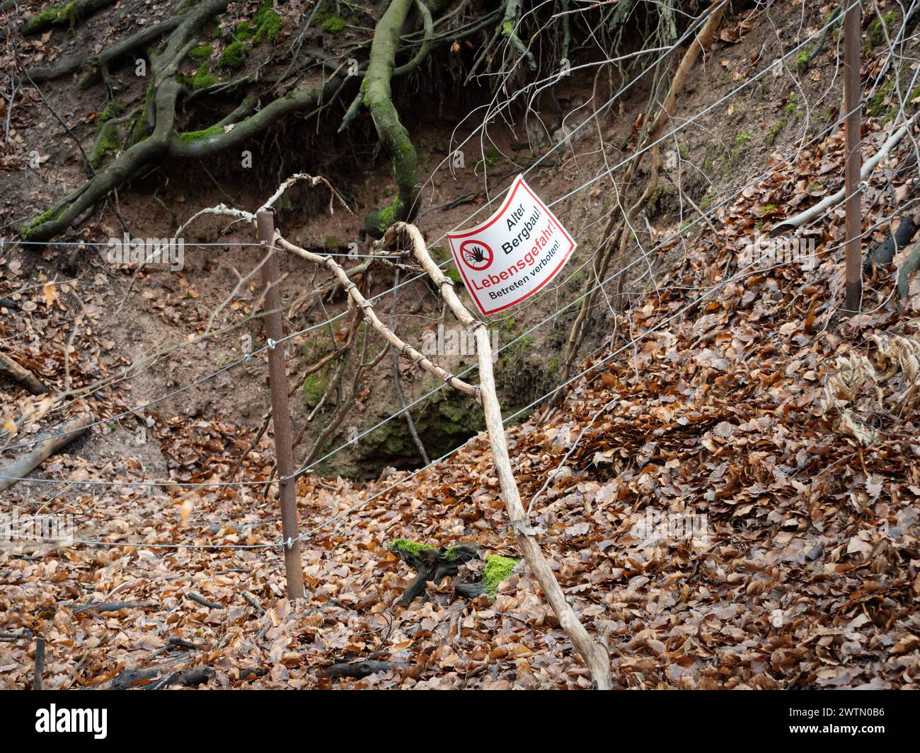Collapsed entrance of an old mine with a danger sign "Lebensgefahr ...
