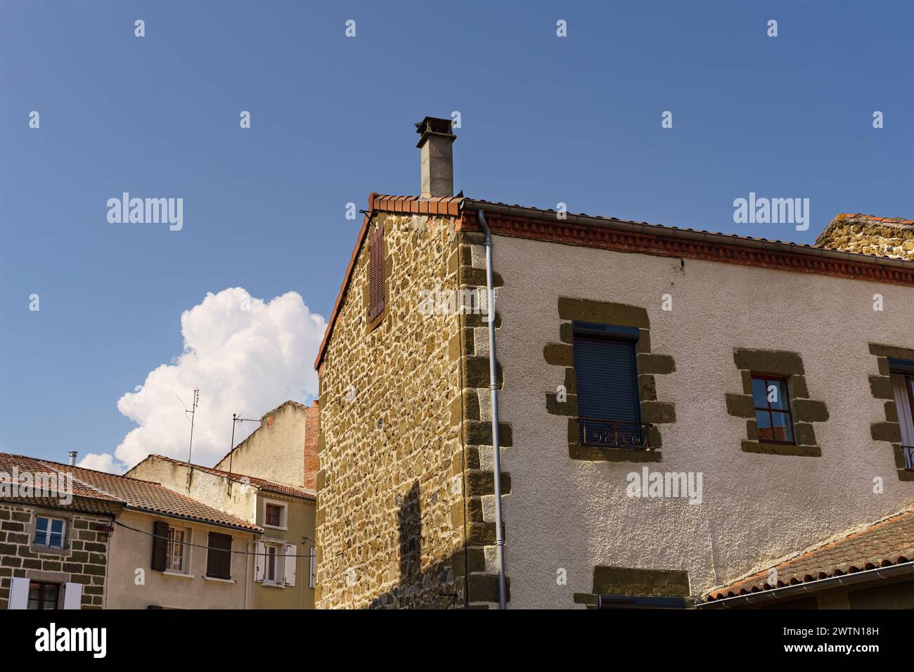 A clock adorns the side of a historic building, showcasing traditional ...