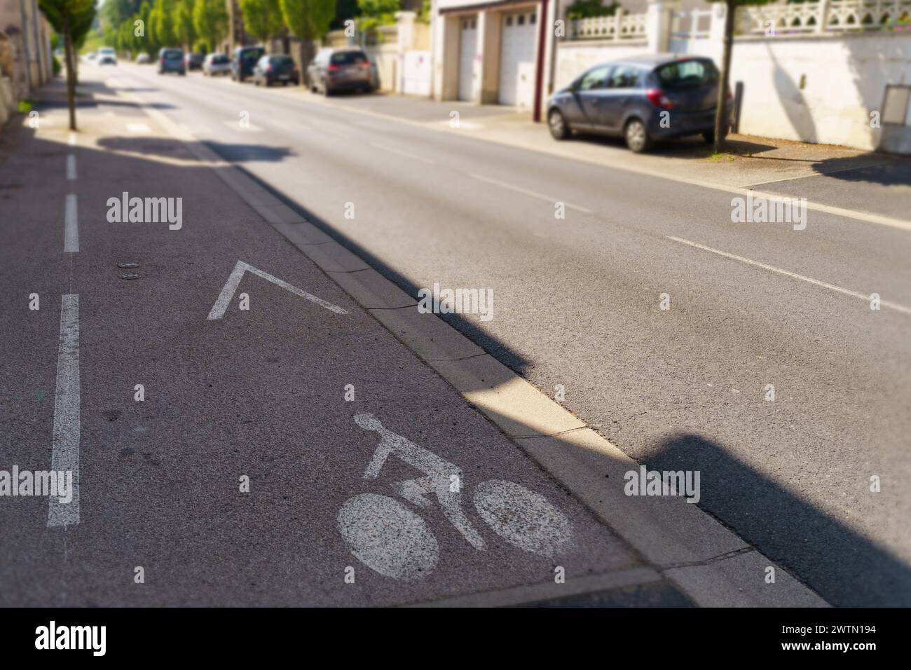 A designated lane for bicycles separated from vehicular traffic by a ...