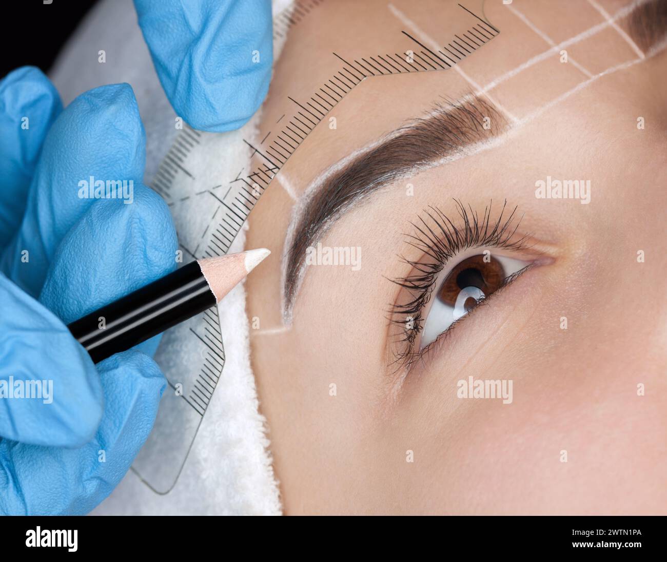 Permanent make-up for eyebrows of beautiful woman with thick brows in ...