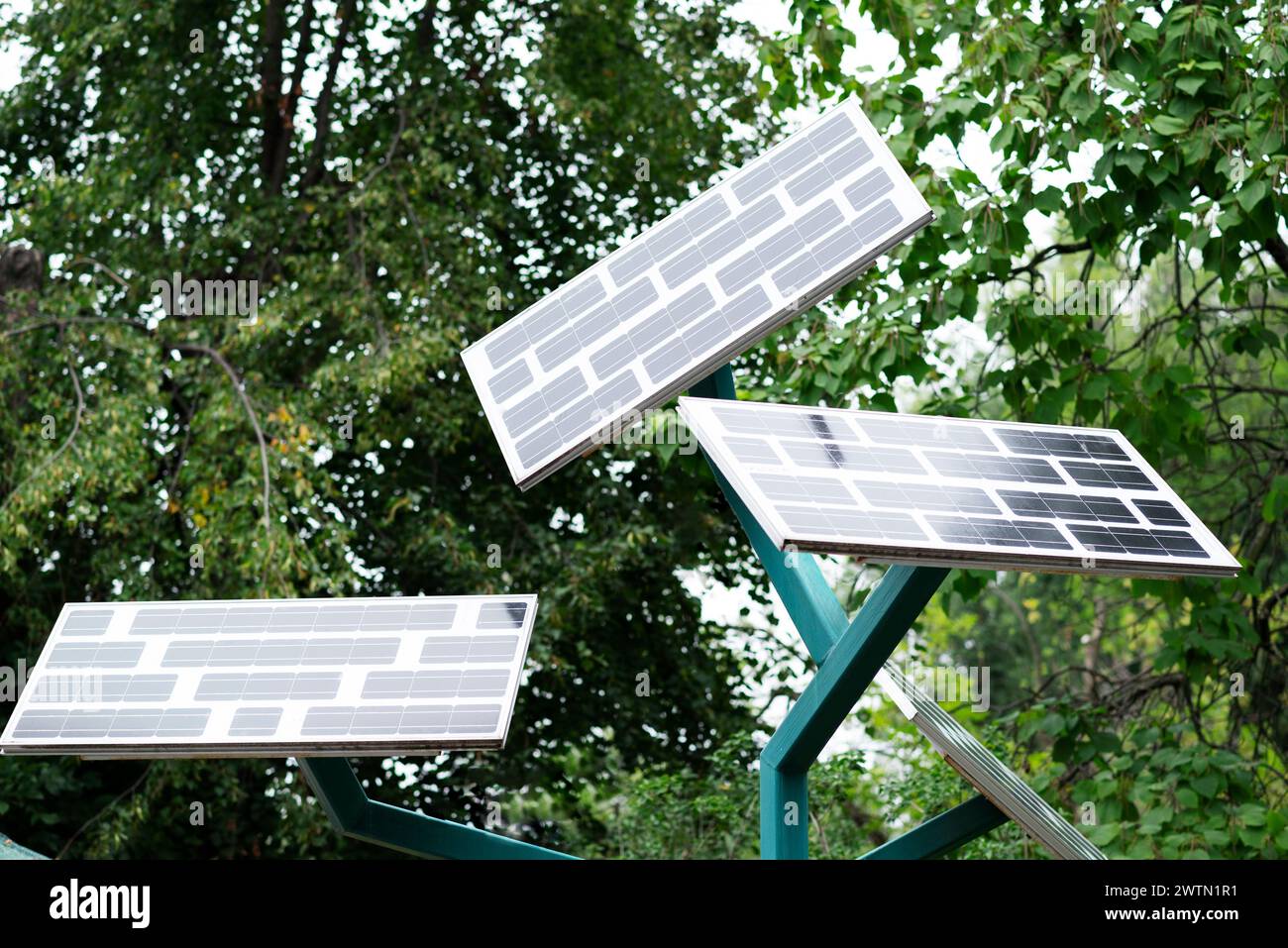 Small Solar Panel mounted on a pole in the summer with green trees ...