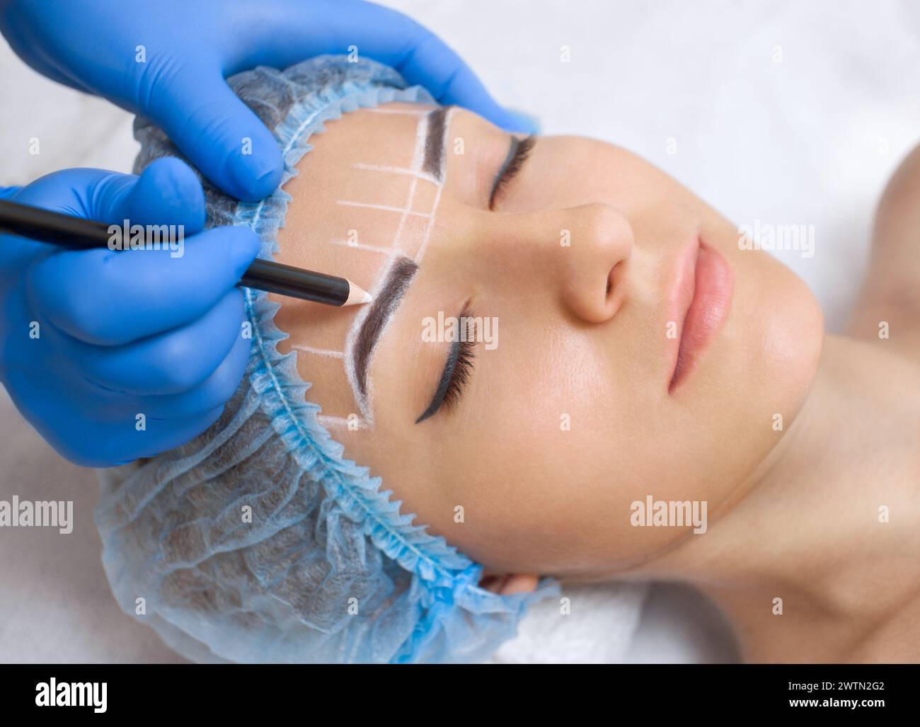 Permanent make-up for eyebrows of beautiful woman with thick brows in ...