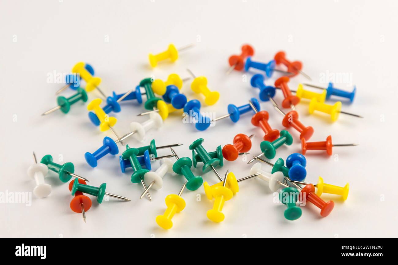 A pile of colourful pins on a white background. A set of pins Stock ...
