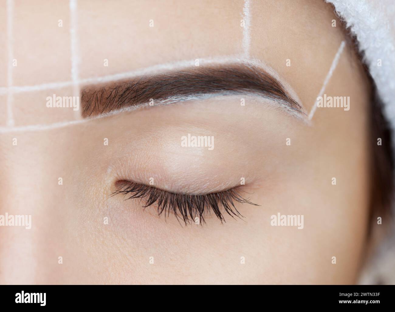 Permanent make-up for eyebrows of beautiful woman with thick brows in ...