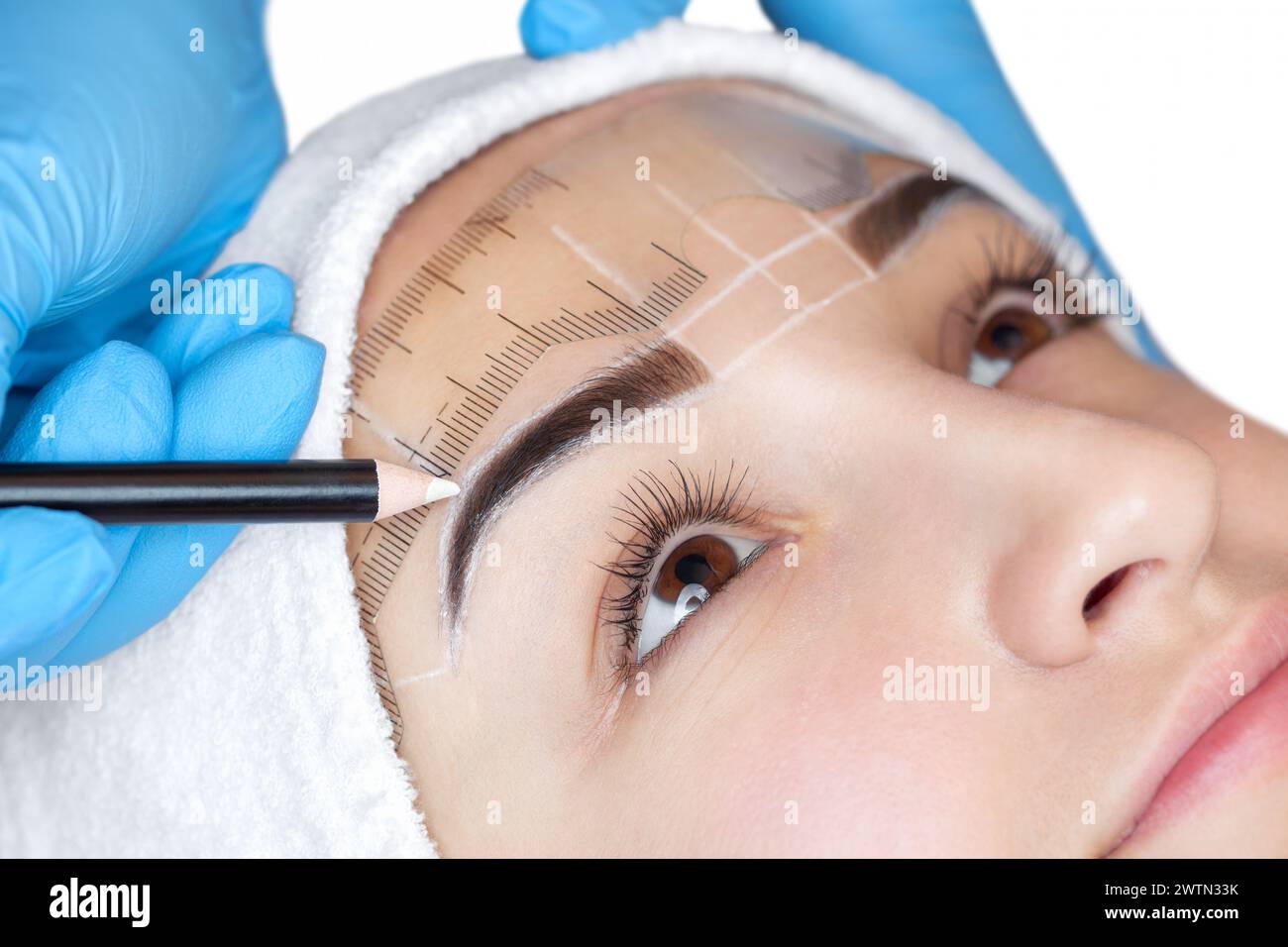 Permanent make-up for eyebrows of beautiful woman with thick brows in ...