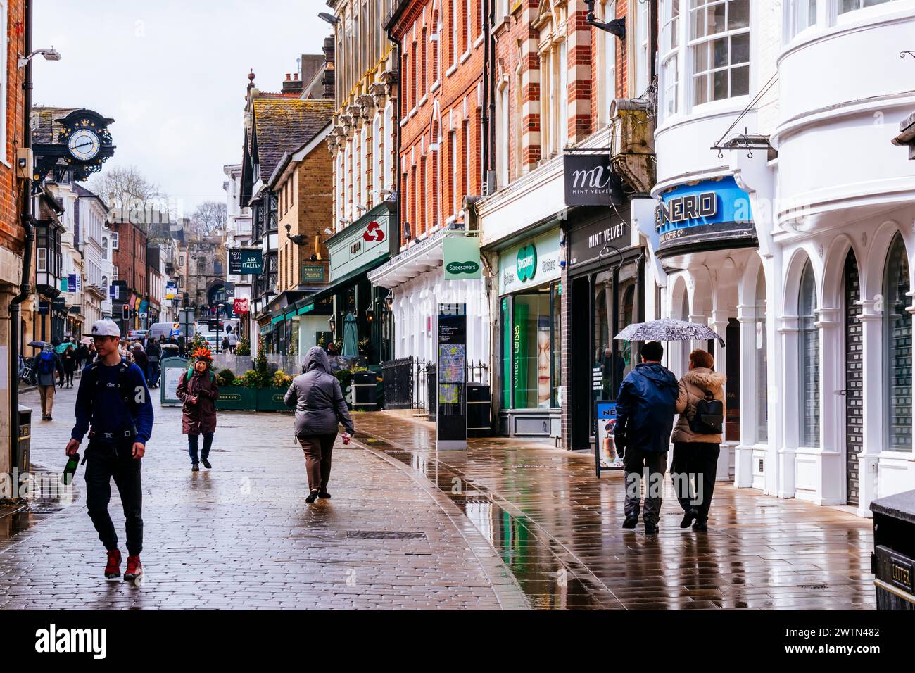 The lively High Street in the city center, a rainy day. Winchester ...