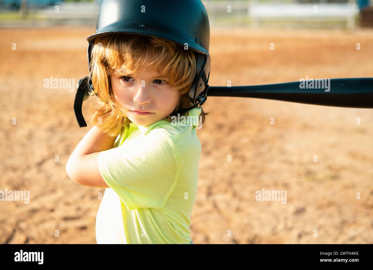 Child baseball player focused ready to bat. Kid holding a baseball bat ...