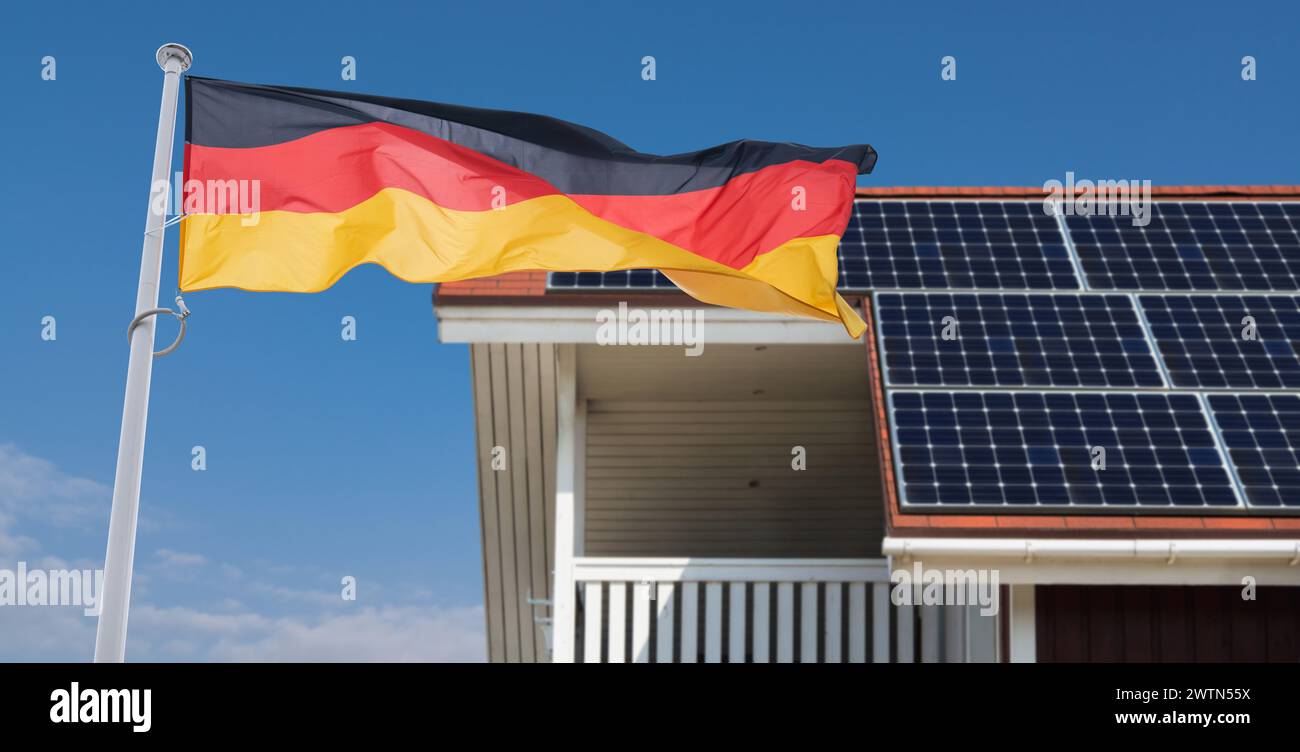 German flag flutters on the background of roof with solar panels Stock ...
