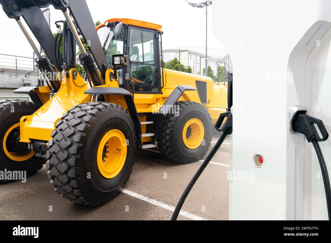 Electric construction machines with charging station. Concept Stock ...