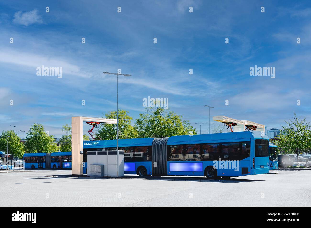 Row of blue buses parked under a cloudy sky in asphalt lot Stock Photo ...