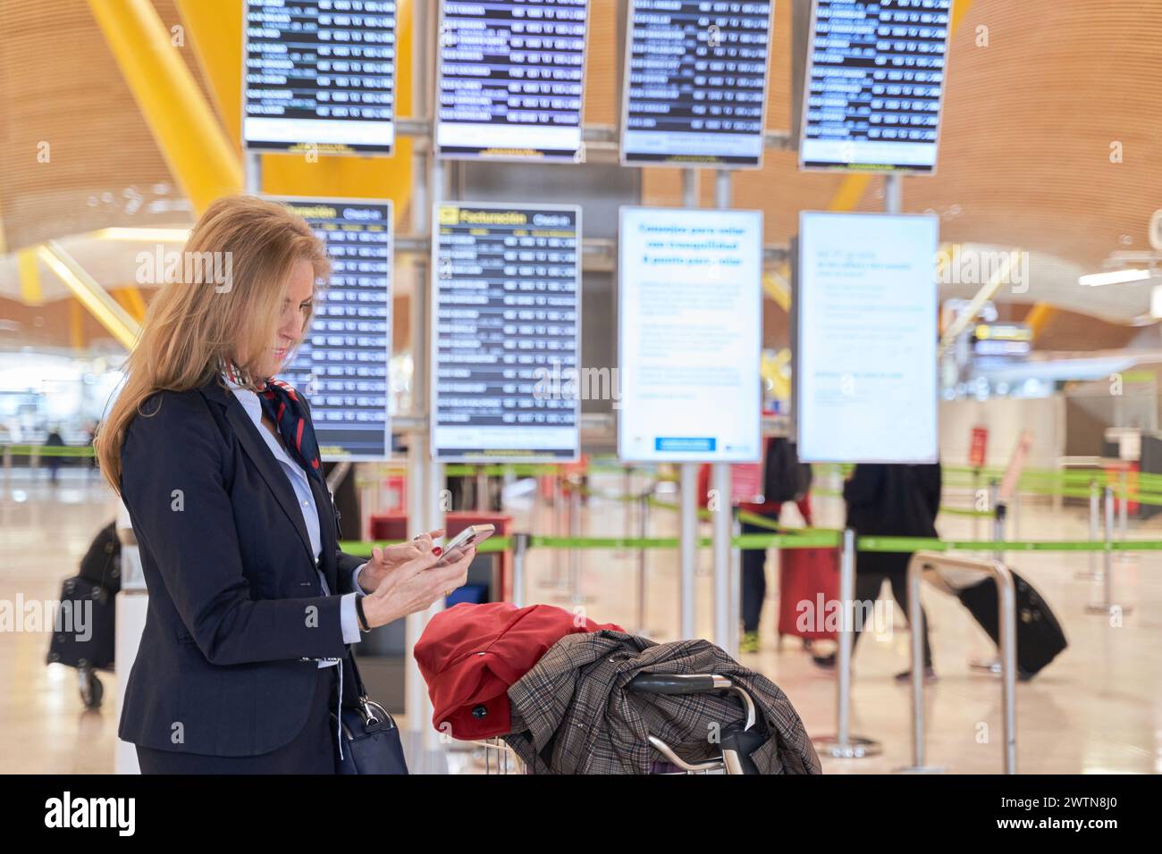 Checking Flight Status: woman Glancing at Phone with Flight Information ...