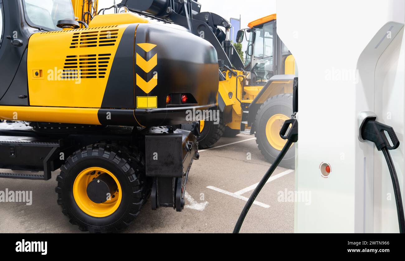 Electric construction machines with charging station. Concept Stock ...