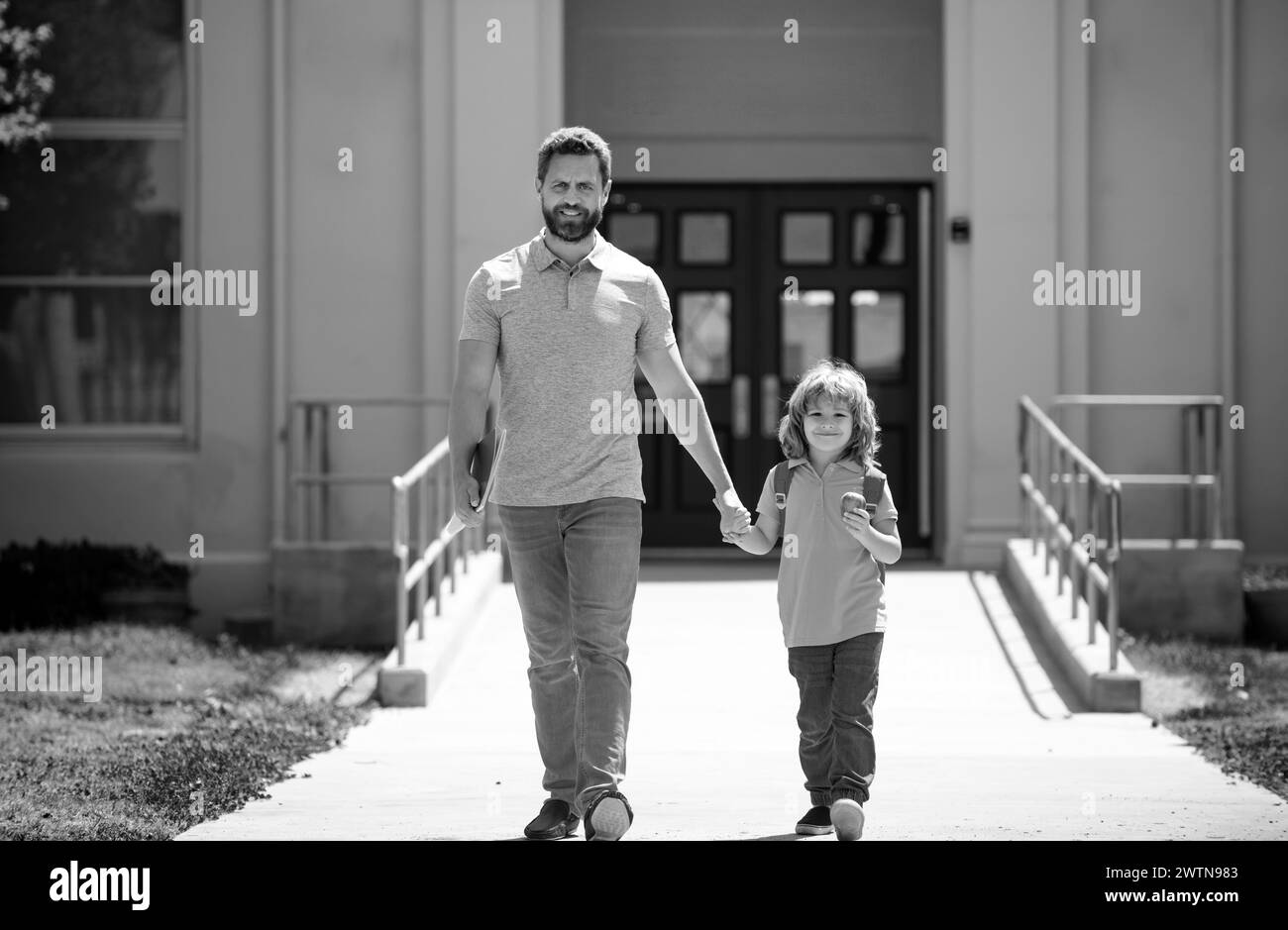 Father supports and motivates son. Kid going to primary school. Parent ...
