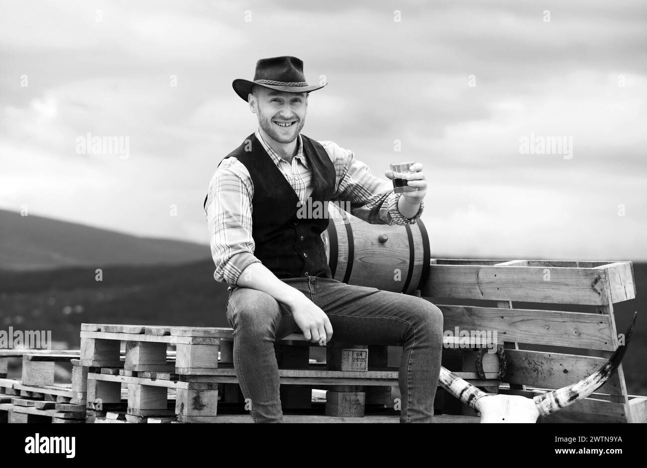 Guy cowboy. Happy owner of ranch drinks a whiskey. Farm worker and ...