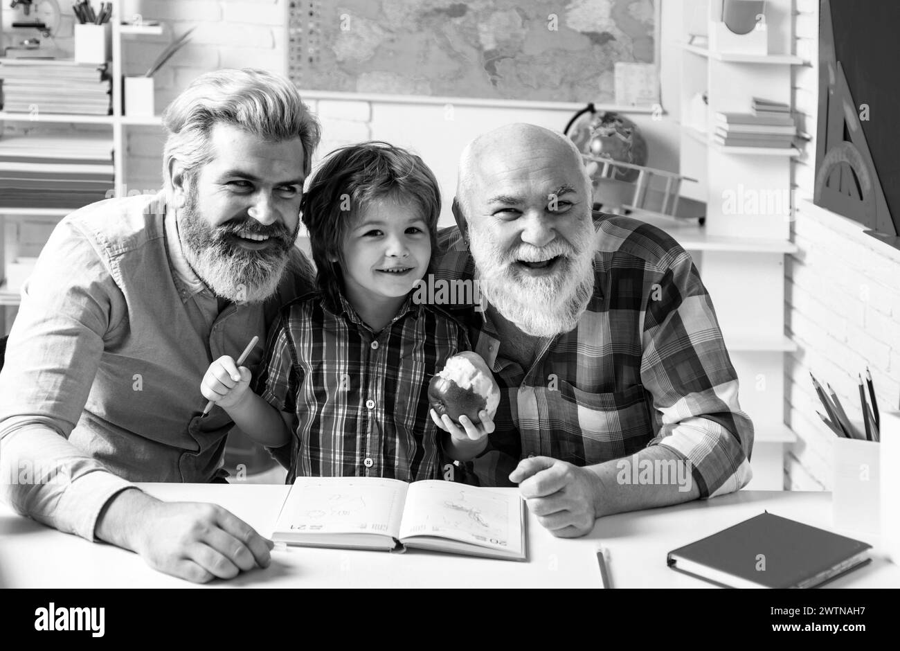 Happy grandfather father and son. Grandpa teaching grangson at home ...