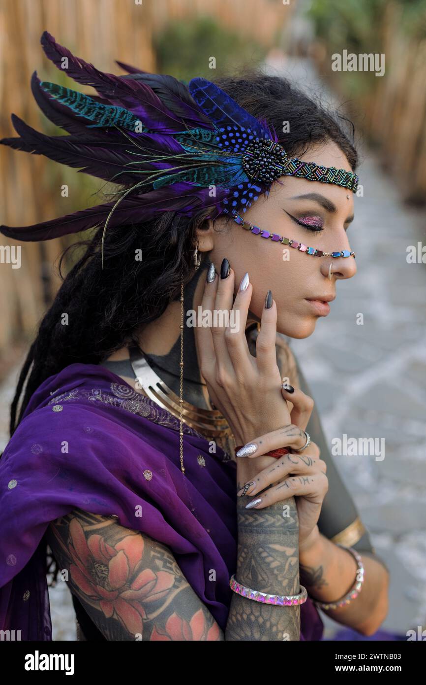 a woman with dreadlocks is wearing a headband with feathers on it Stock ...