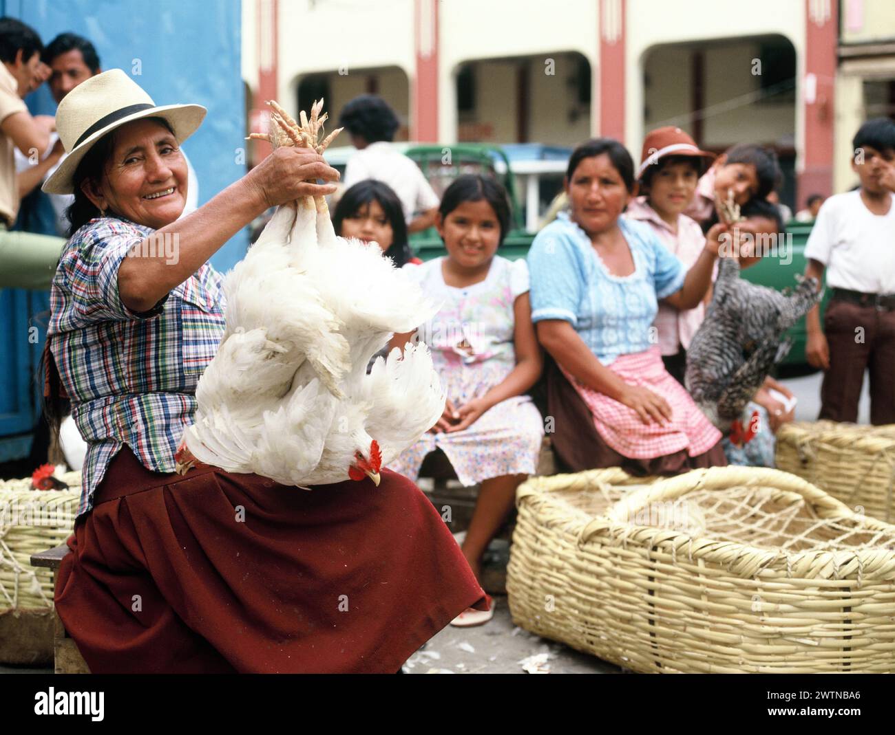 Peru. Lima. Local woman in food market, holding a chicken Stock Photo ...