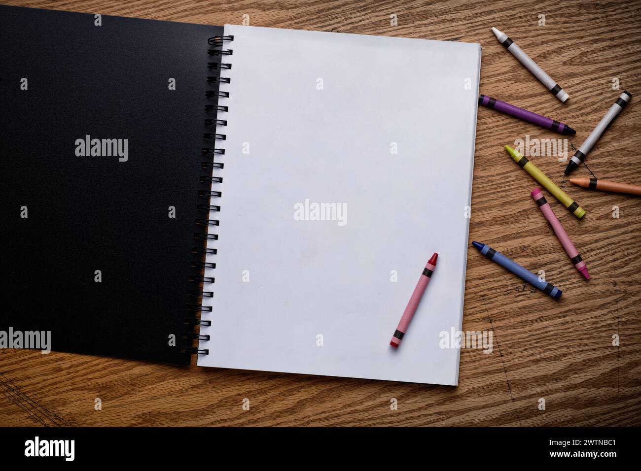 Kids drawing with crayons at a table hi-res stock photography and ...