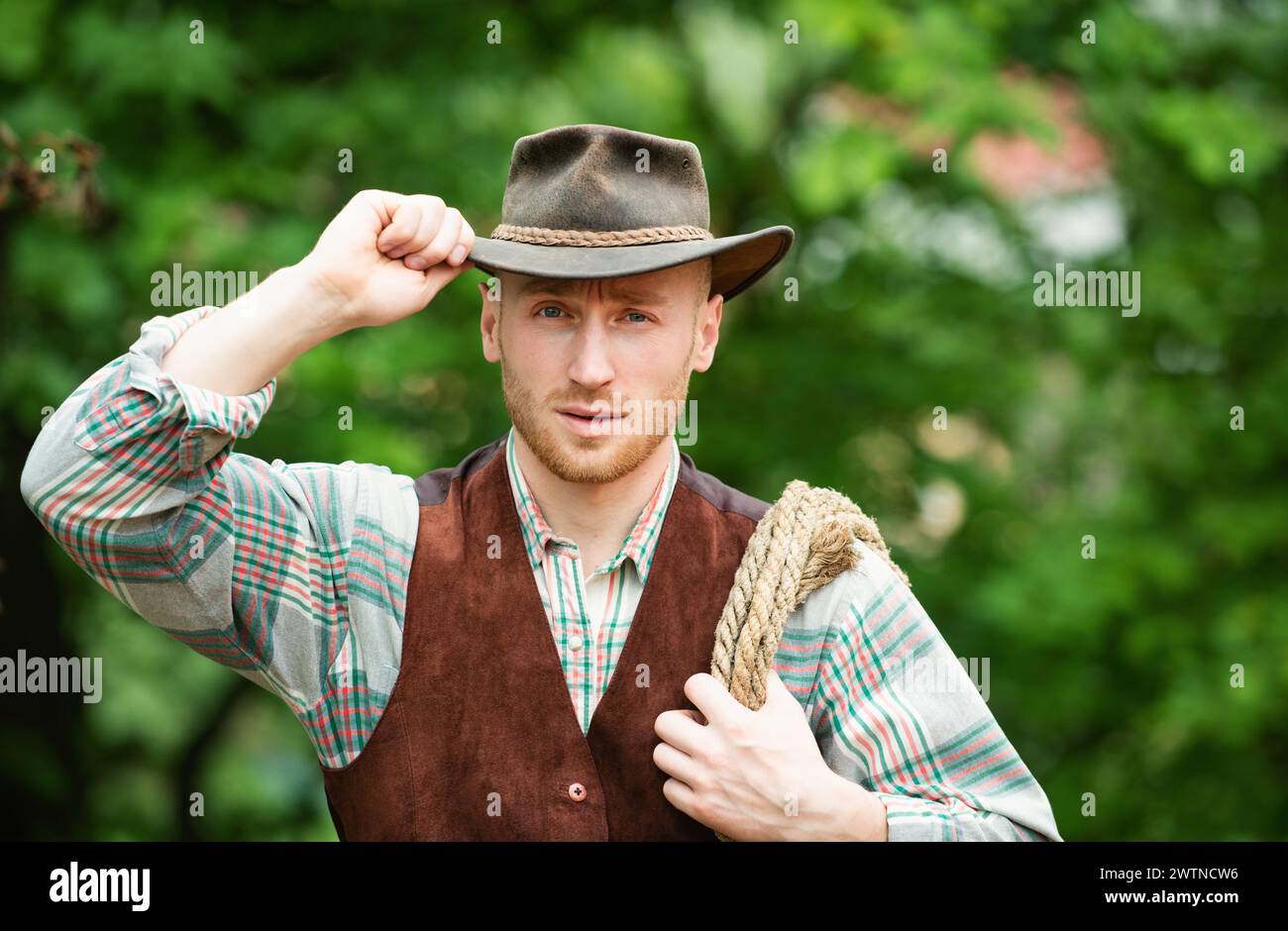 Cowboy farmer man in country side wearing western cowboy hat. Cowboy ...