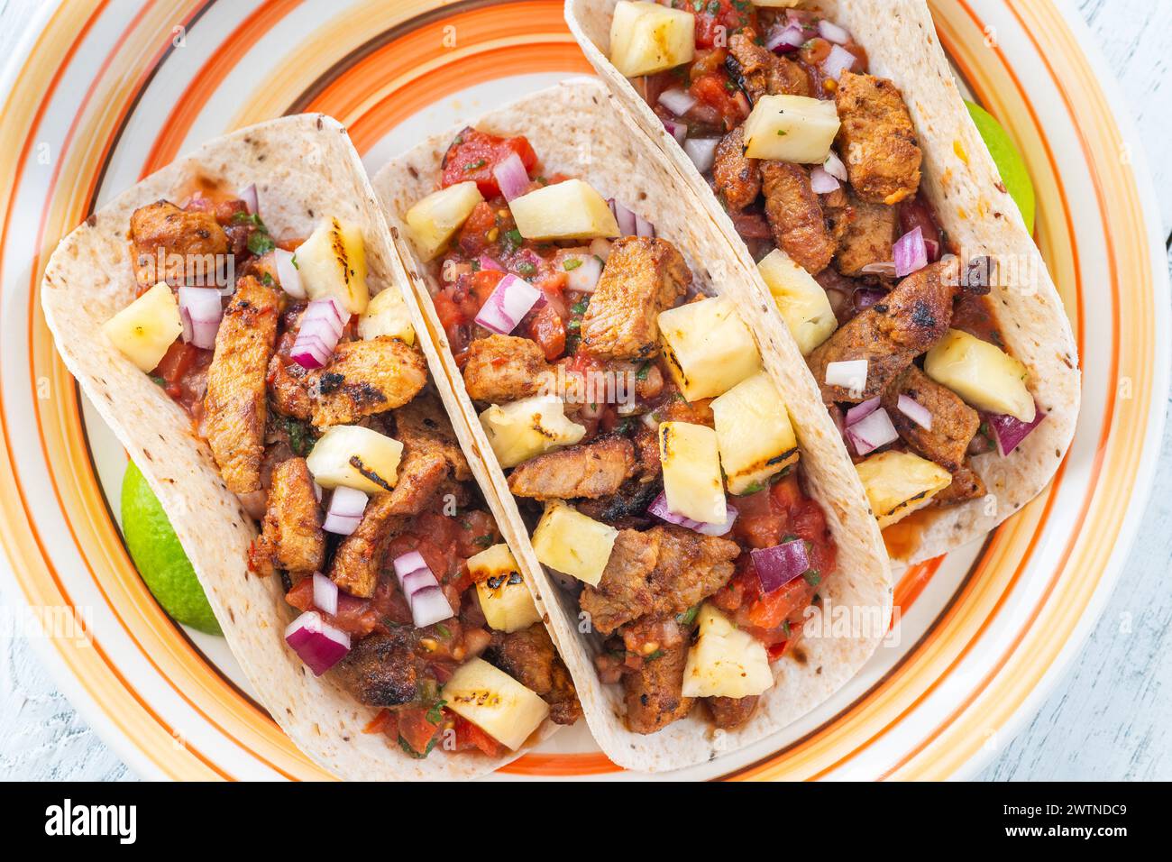 Tacos al pastor mexican dish with pork and pineapple Stock Photo - Alamy