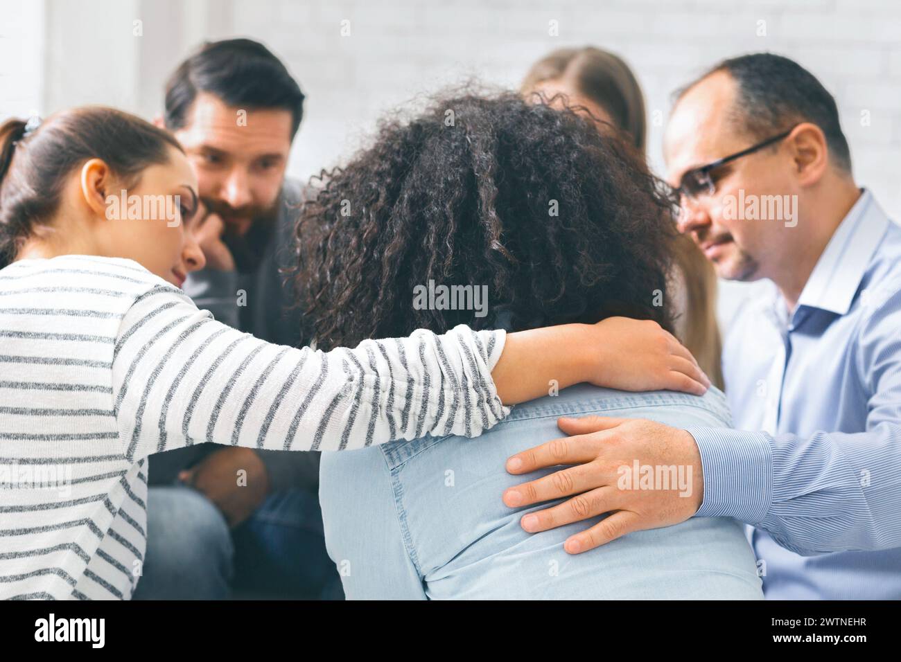 Female psychiatrist comforting young crying hi-res stock photography ...