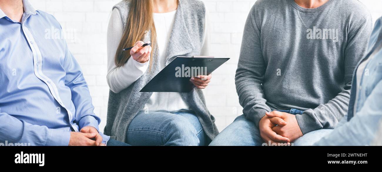 Psychotherapist talking with patients during group therapy session and ...