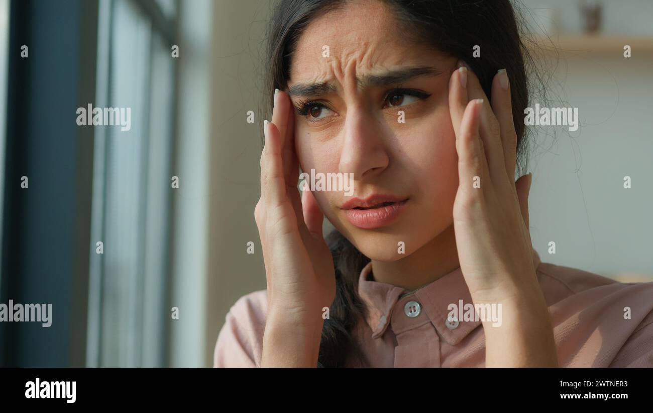 Tired sick woman arabian indian girl near window at home suffer from ...