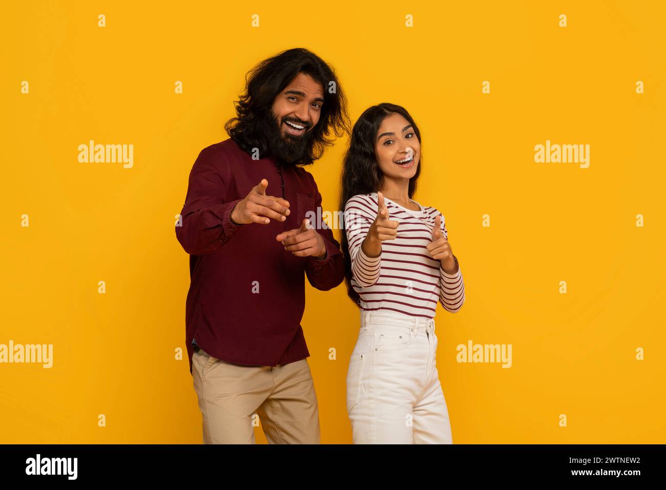 Couple pointing at viewer with excited expressions Stock Photo - Alamy