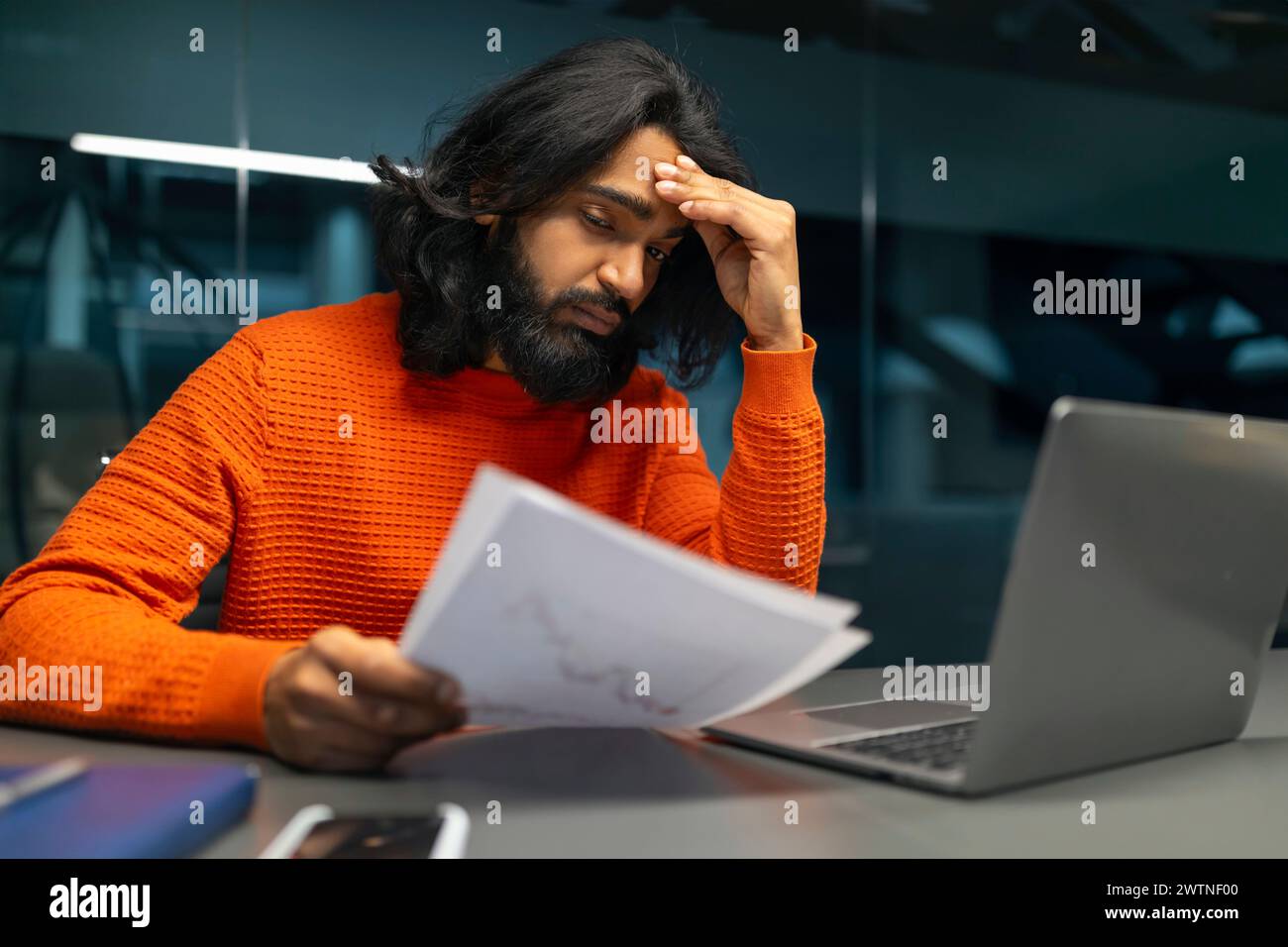 Man with headache over paperwork Stock Photo - Alamy