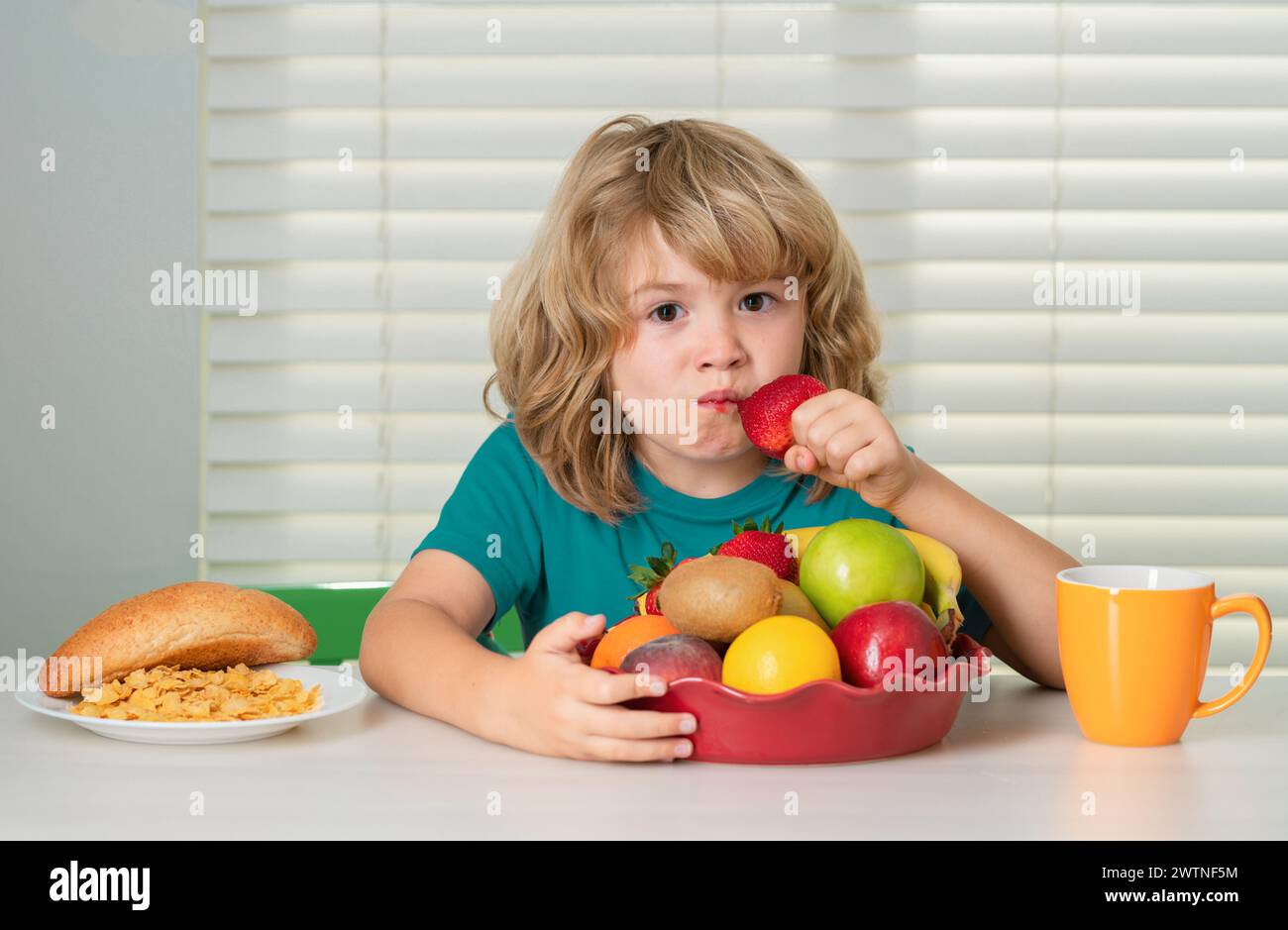 Child eats strawberry, organic fruits. Kid preteen boy 7, 8, 9 years ...