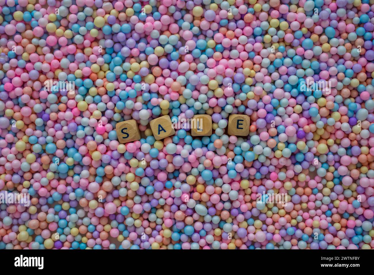 SALE word written on wood block. top view on background from small ...