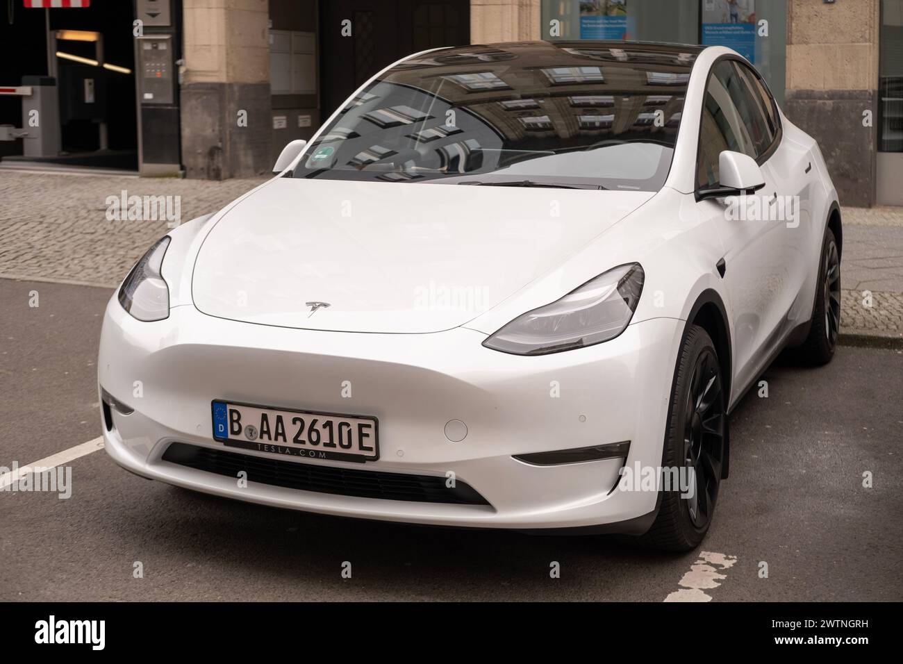 white Tesla Model y car on street of Berlin, eco-friendly vehicle in ...
