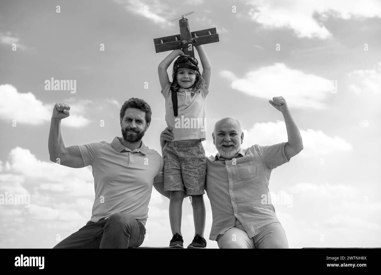 Fathers day. Kid having fun with toy plane. Men generation family with ...