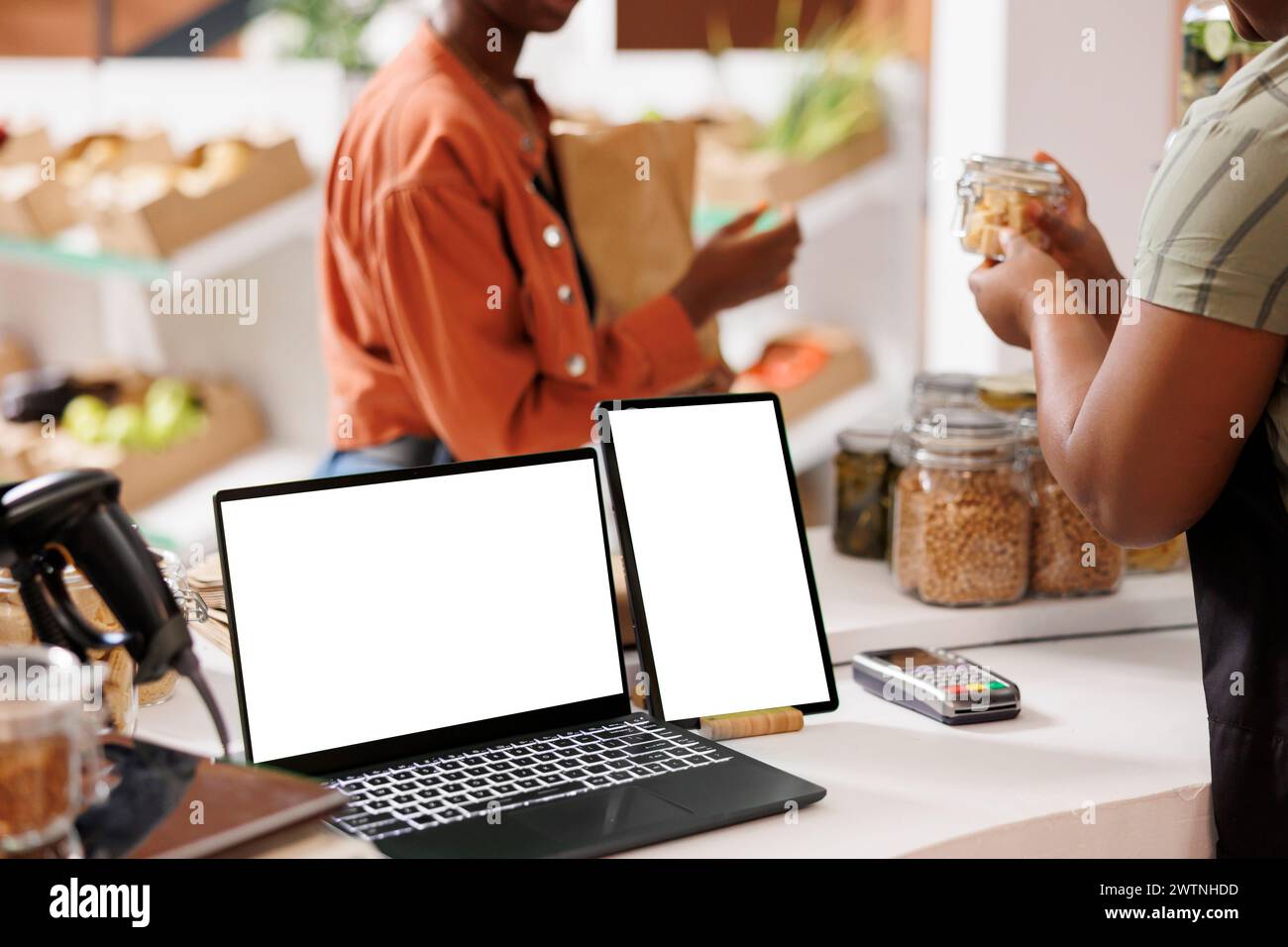 Digital screens on counter showing blank chromakey mockup template ...