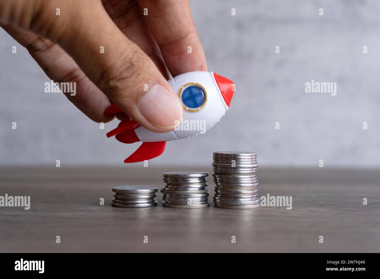 Closeup image of rocket spaceship and coins. Business startup, launch ...